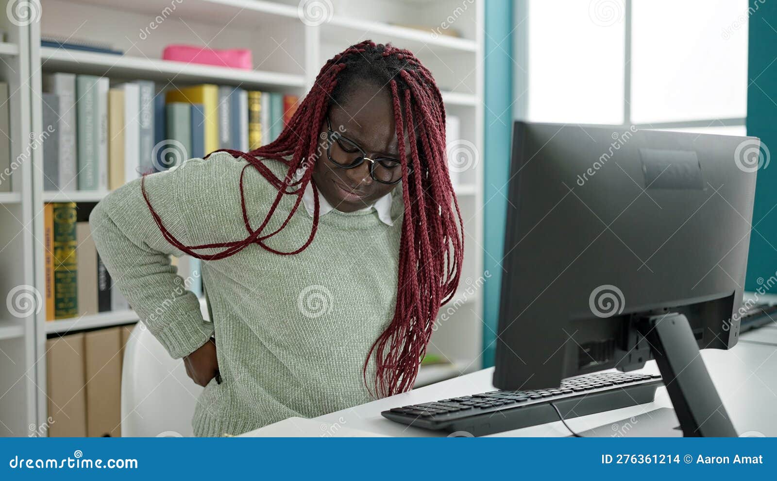 African Woman with Braided Hair Student Using Computer with Backache at ...
