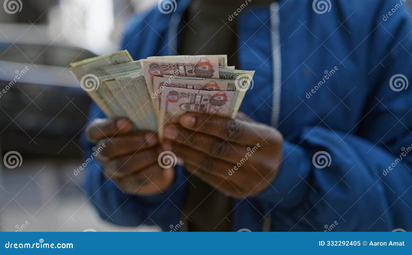 African Woman Counting Dirhams Outdoors in an Urban Setting Stock Image ...