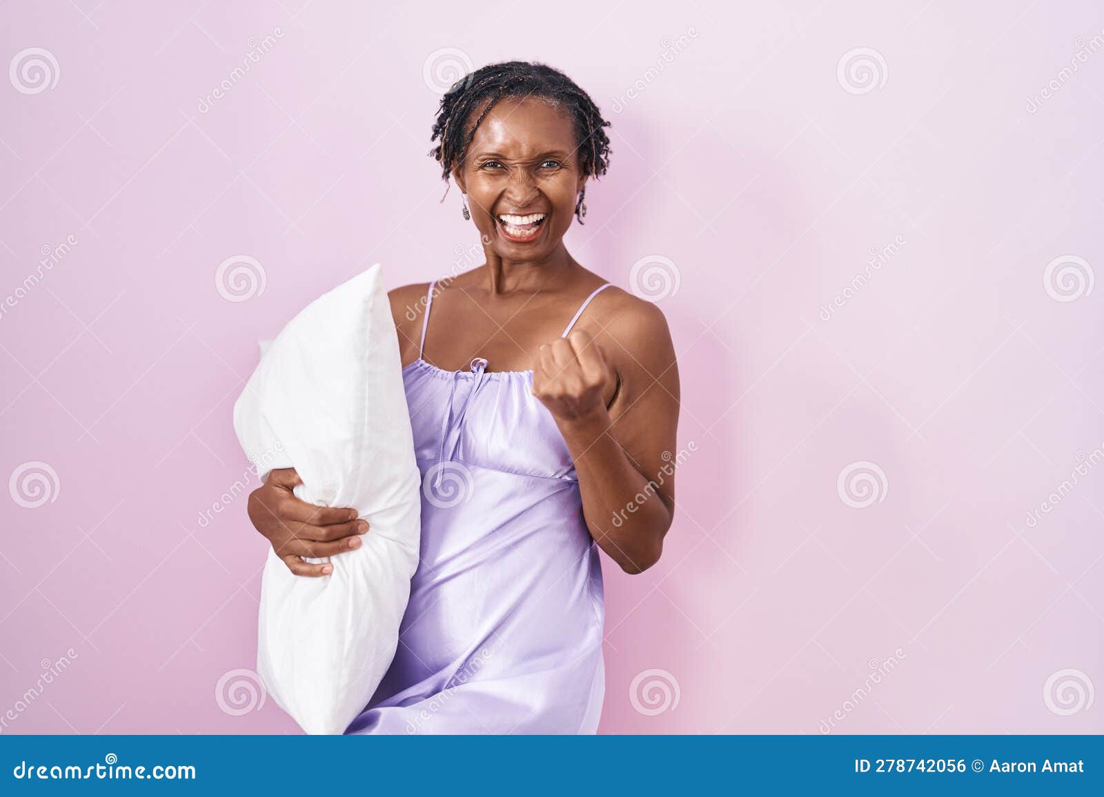 African Woman With Dreadlocks Wearing Pajama Hugging Pillow Very Happy