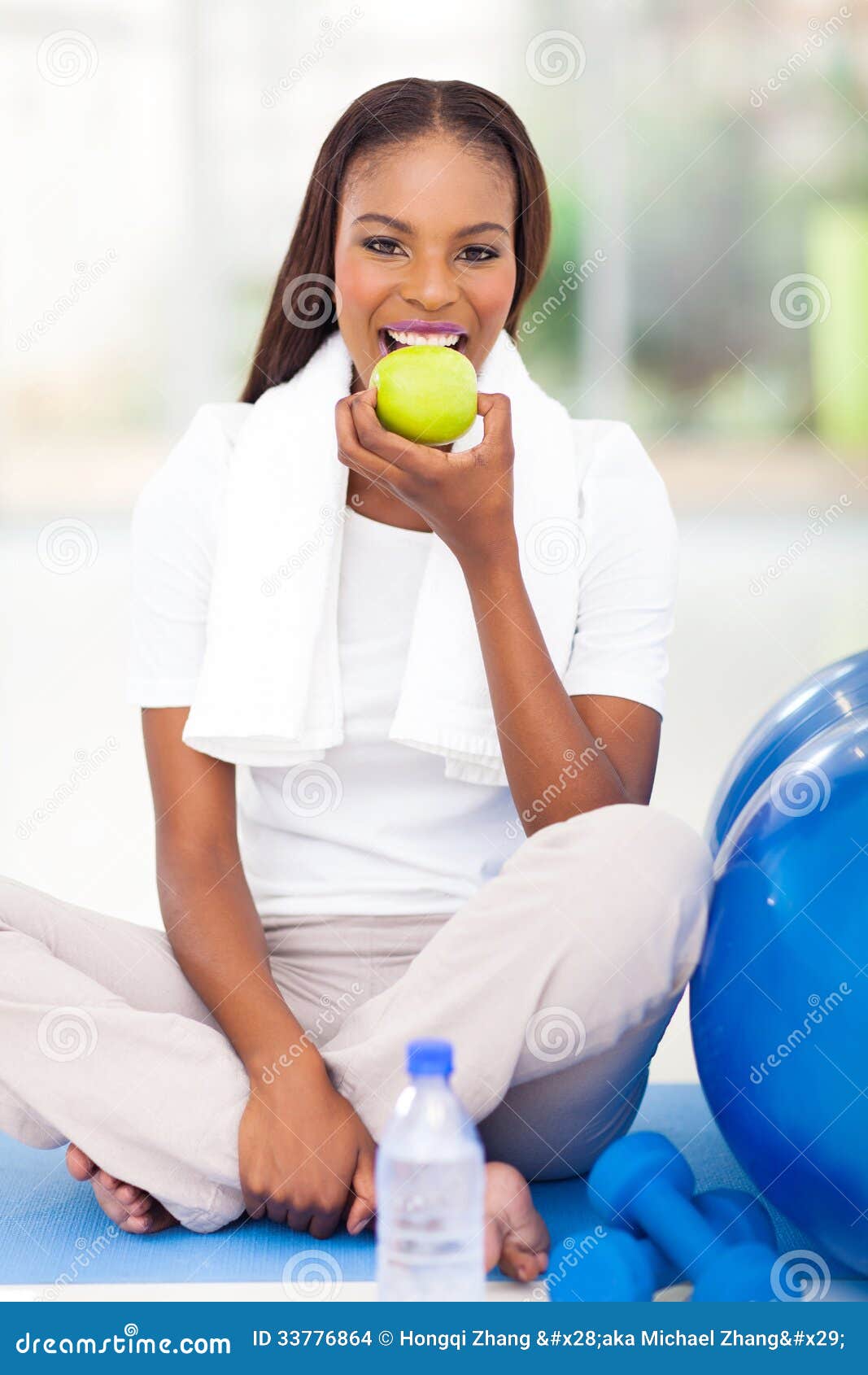 African woman eating apple stock photo. Image of fitness - 33776864