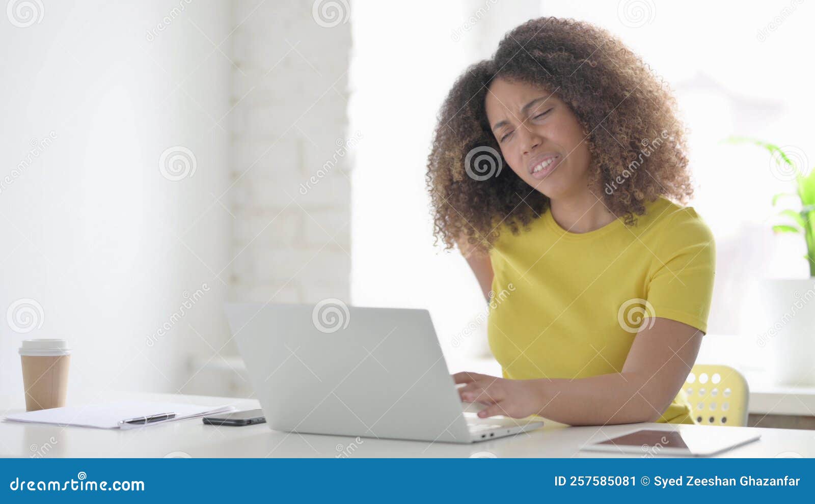 African Woman Having Back Pain while Using Laptop in Office Stock Image ...