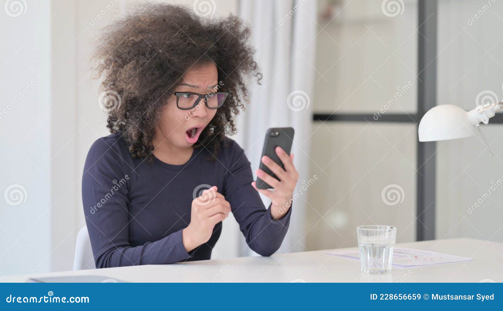 African Woman Having Loss while Browsing Internet on Smartphone Stock ...