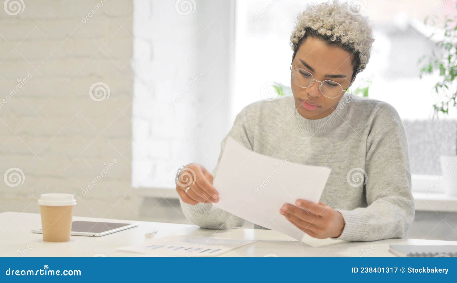 African Woman Reading Reports while Sitting in Office Stock Image ...