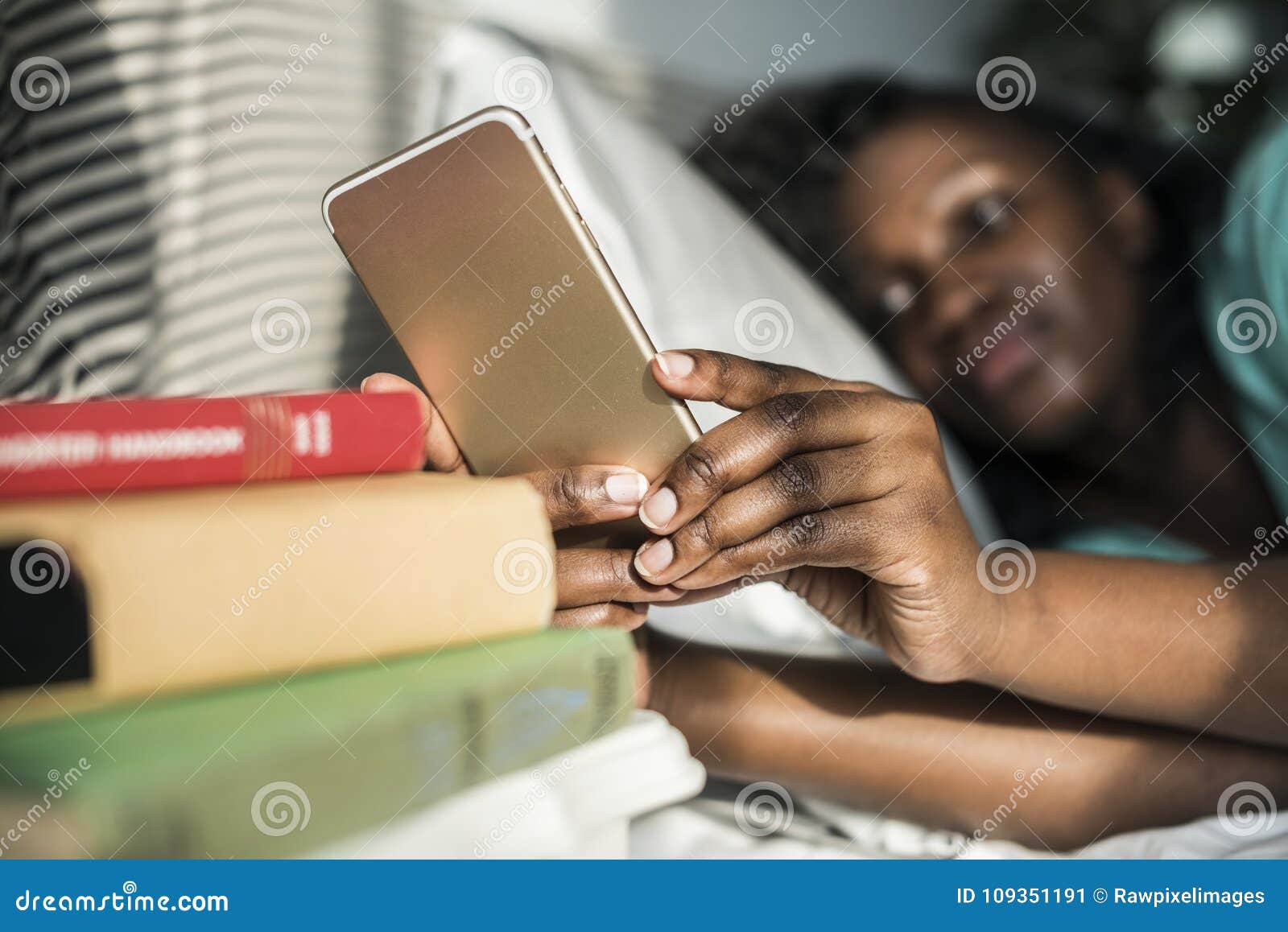 African Woman Using Phone on Bed Stock Image - Image of connection ...