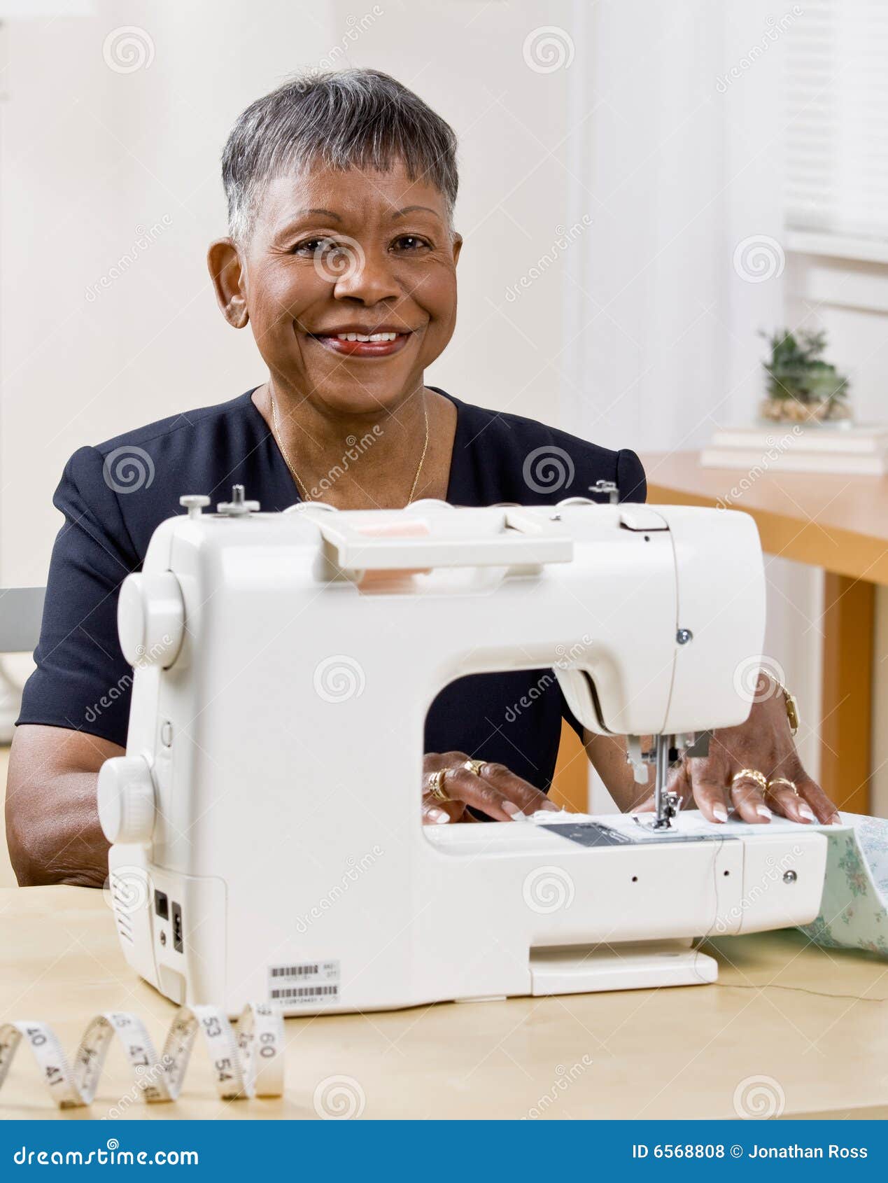 African Woman Using Sewing Machine Stock Photo - Image of mature ...