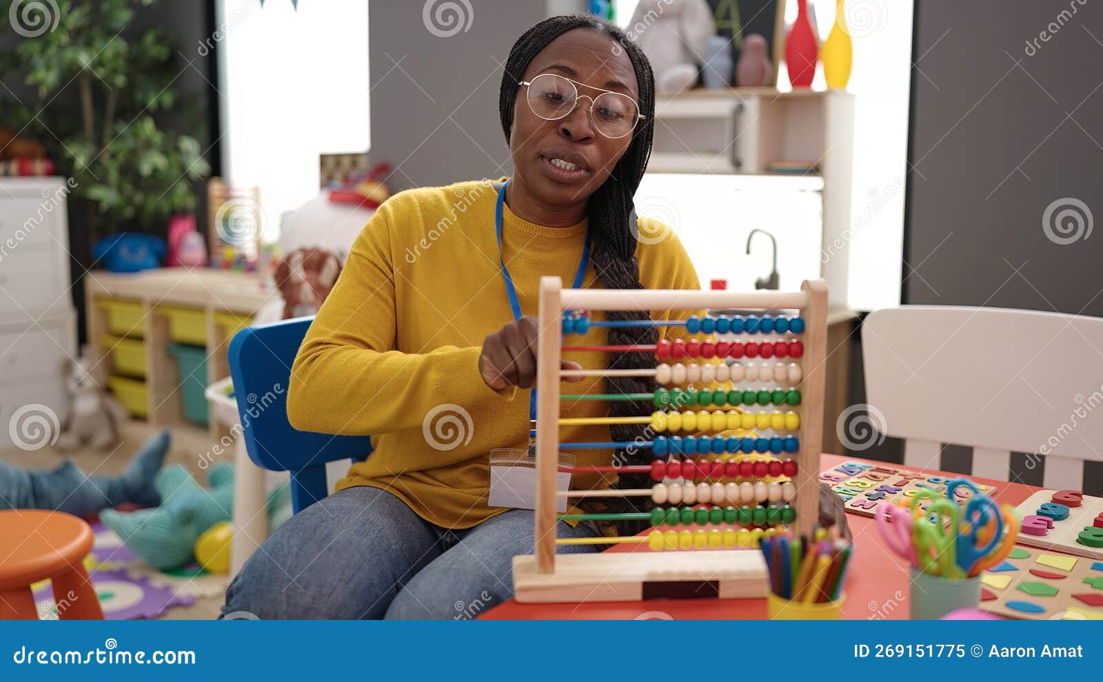 African Woman Working As Teacher Teaching Maths with Abacus at ...