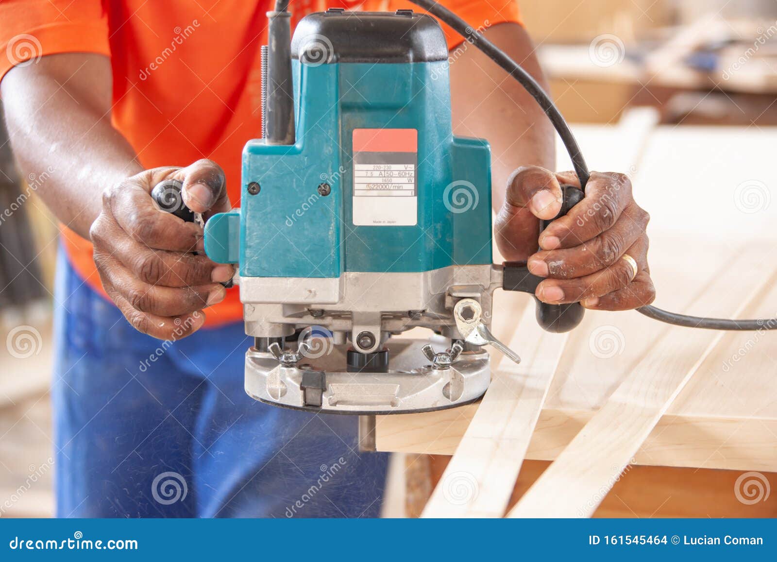 Carpenter using a router stock photo. Image of green - 161545464