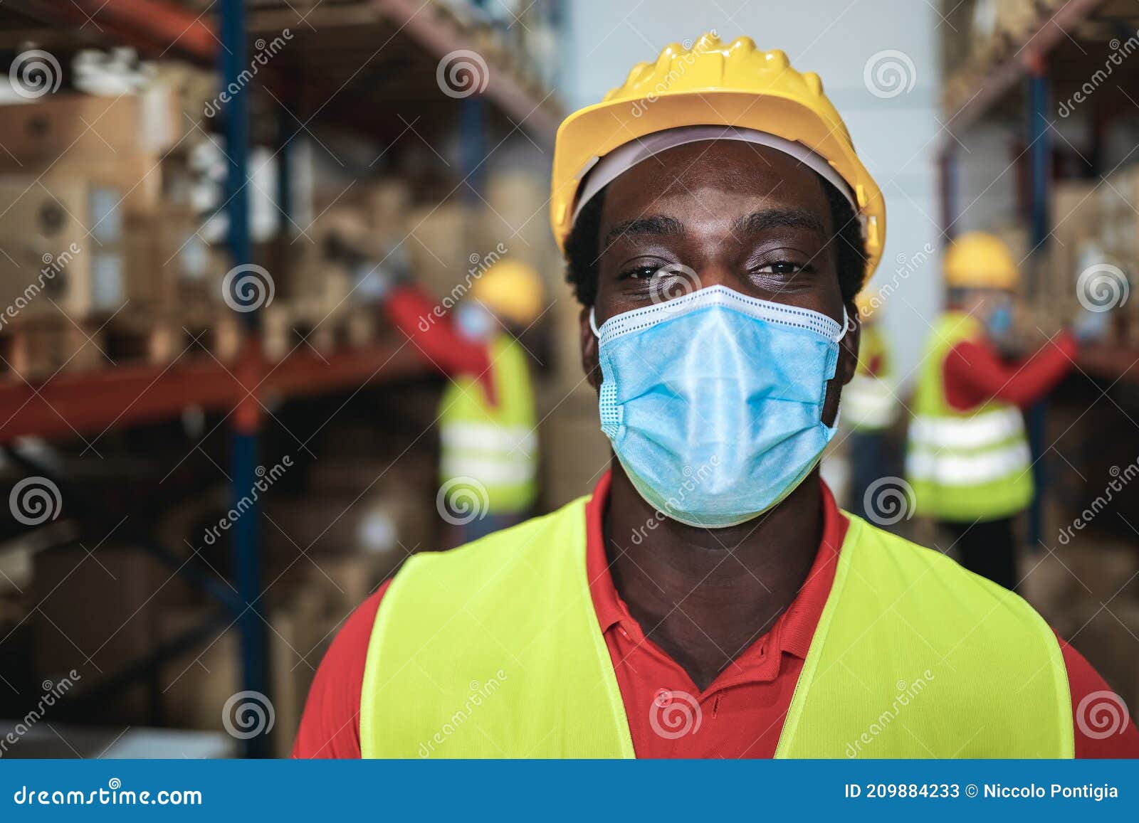 African Worker Man Looking at Camera Inside Warehouse while Using ...
