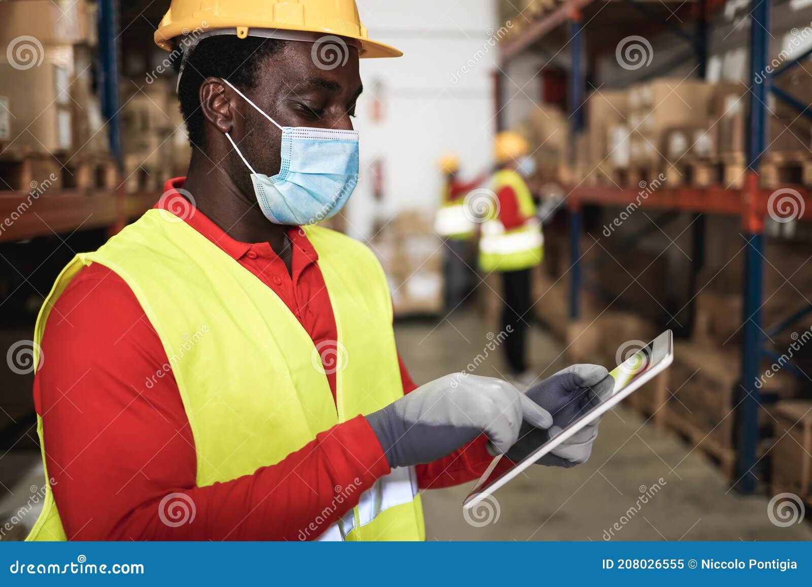 African Worker Man Using Tablet Inside Warehouse while Wearing Safety ...