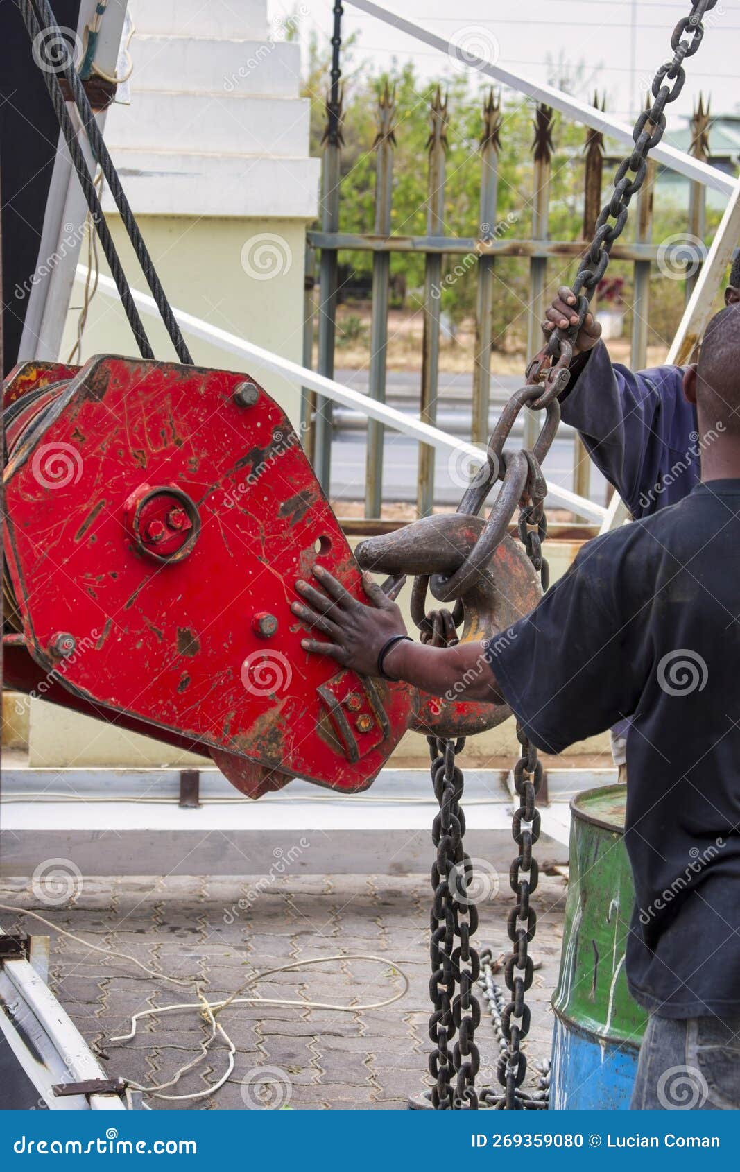 African Worker Securing a Crane Hook Stock Photo - Image of mechanical ...