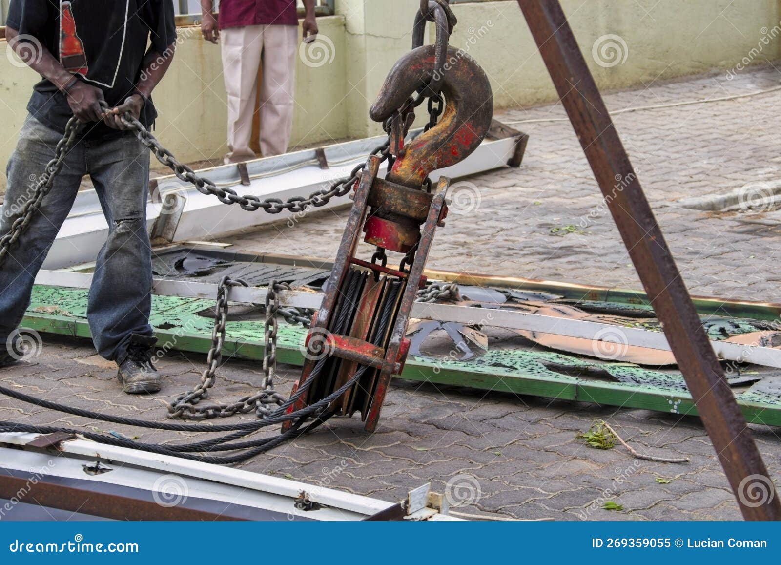 African Worker Using a Chain on a Crane Hook Stock Image - Image of ...