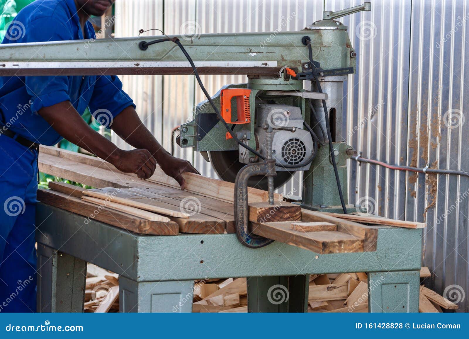 African worker with a saw stock photo. Image of industrial - 161428828