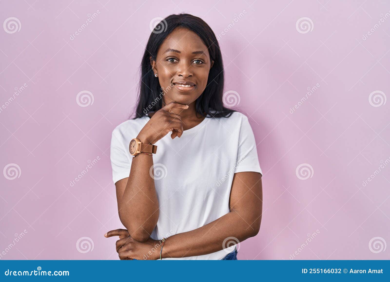 African Young Woman Wearing Casual White T Shirt With Hand On Chin