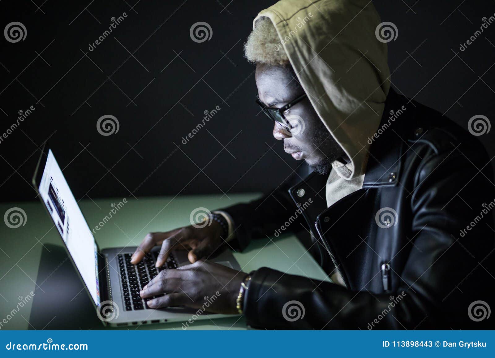 Afro American Hacker in Hood Using Laptop Computer in the Dark Hack ...