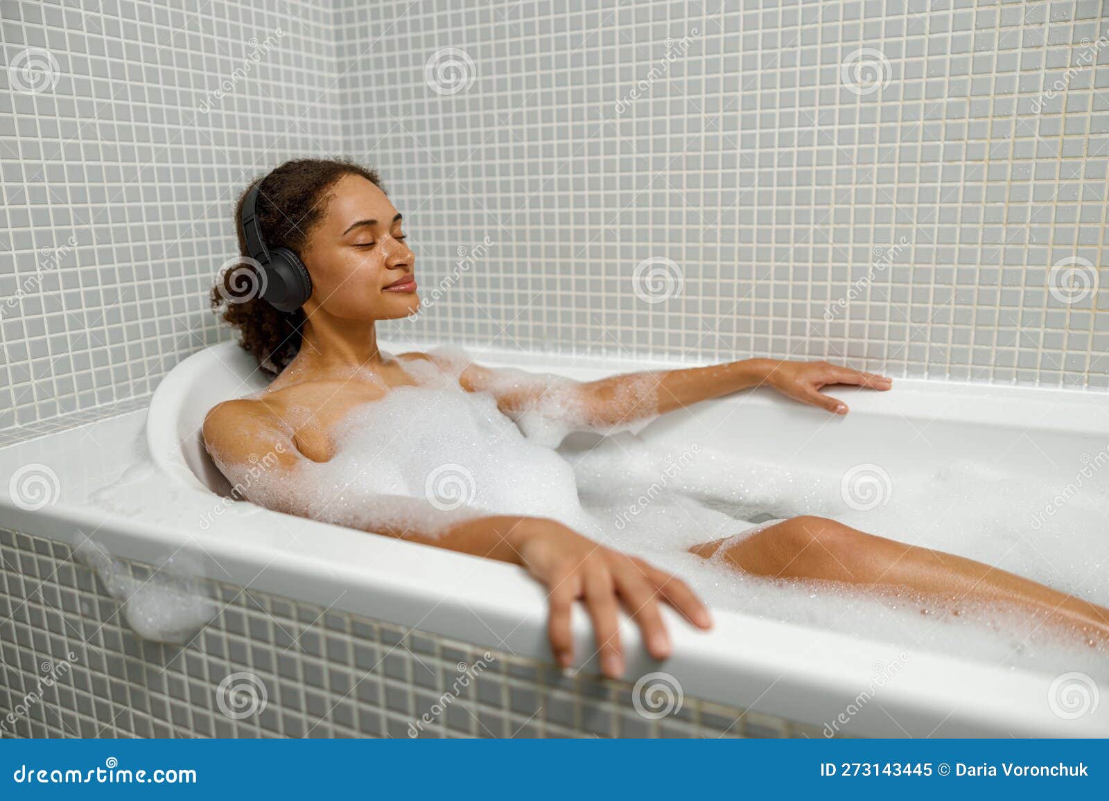 Afro American Woman Takes Bubble Bath In Bathtub And Listen Music
