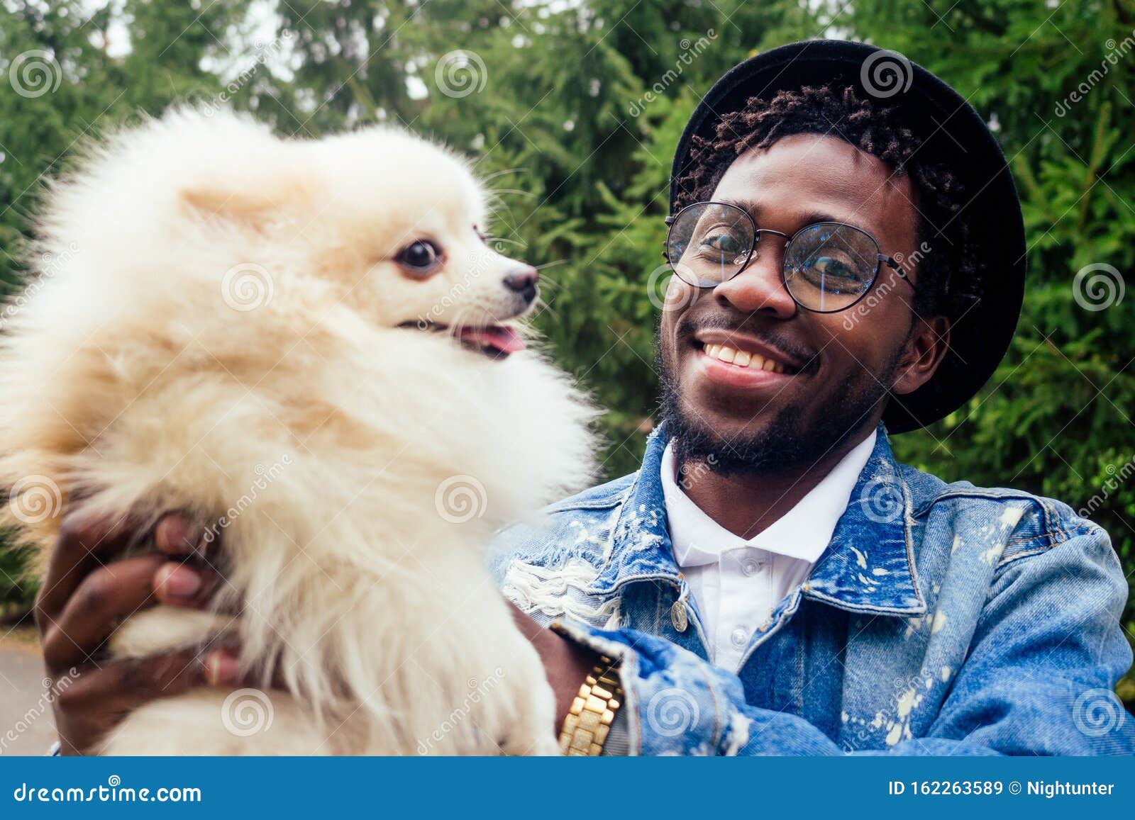 Afro Man Hugging His Fluffy Spitz in Park Stock Image - Image of ...