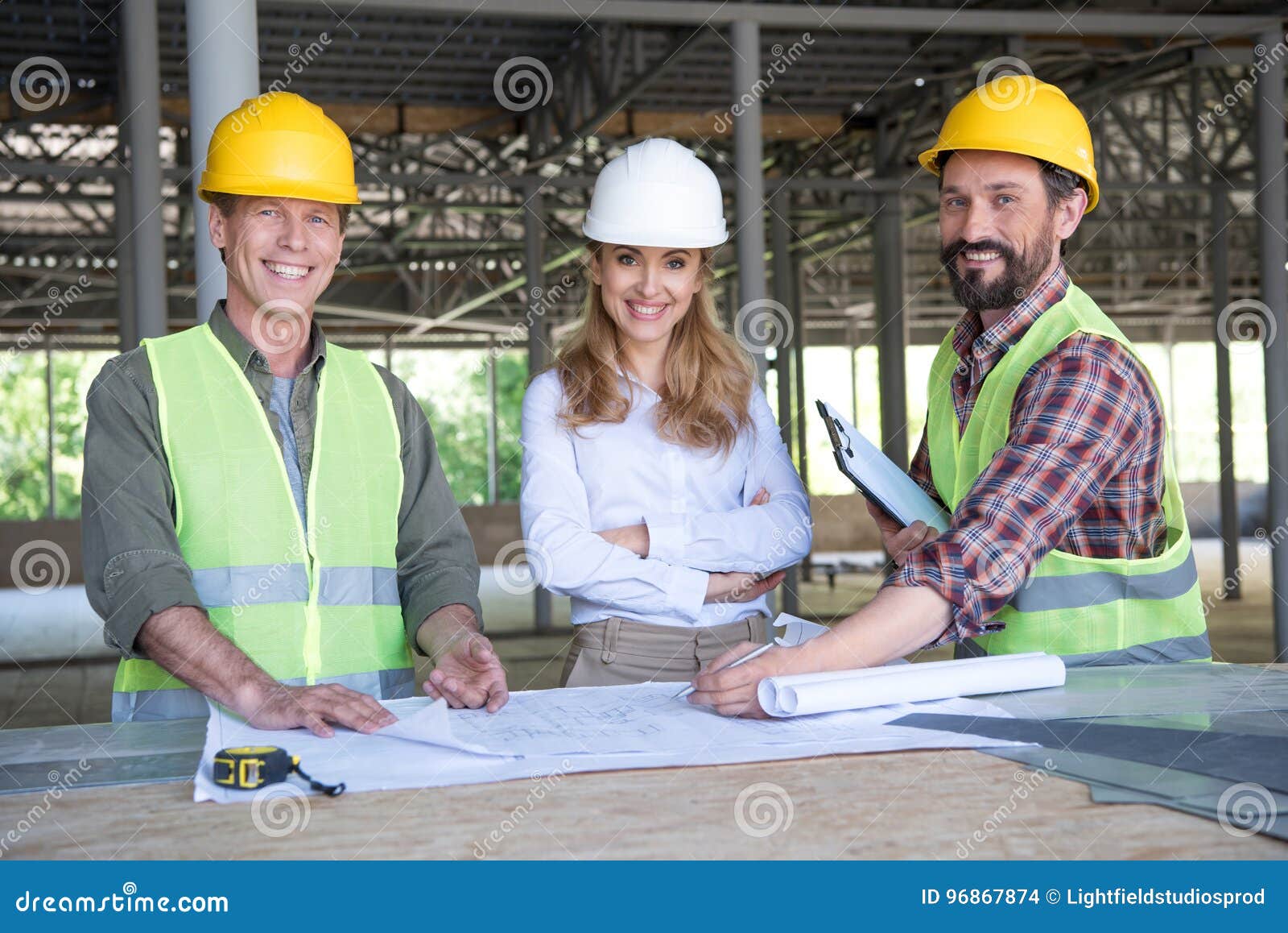 Aged Constructors and Contractor Looking at Camera during Work on ...