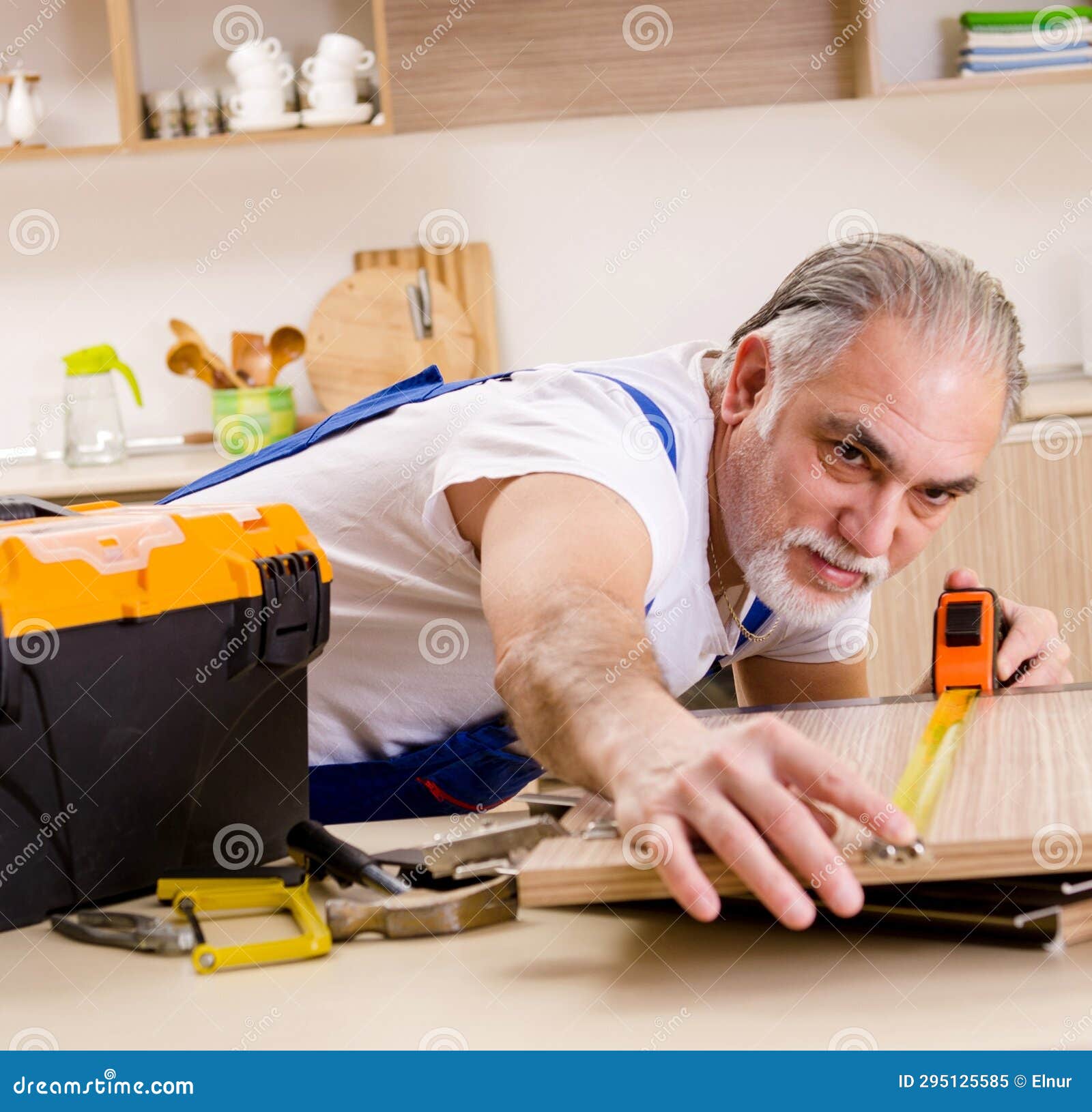 Aged Contractor Repairman Working in the Kitchen Stock Image - Image of ...