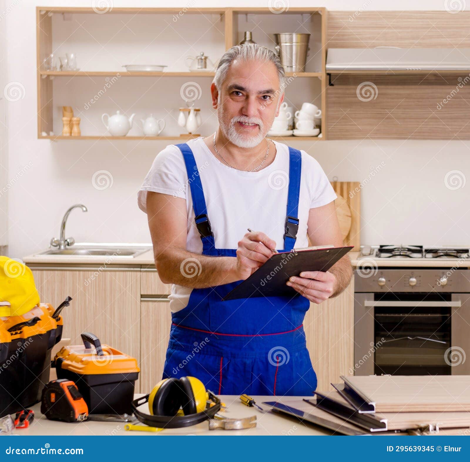 Aged Contractor Repairman Working in the Kitchen Stock Image - Image of ...