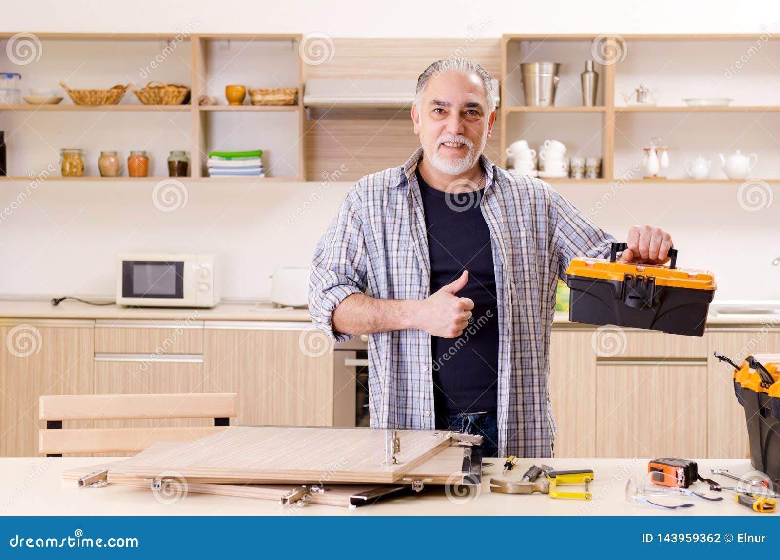 The Aged Contractor Repairman Working in the Kitchen Stock Photo ...