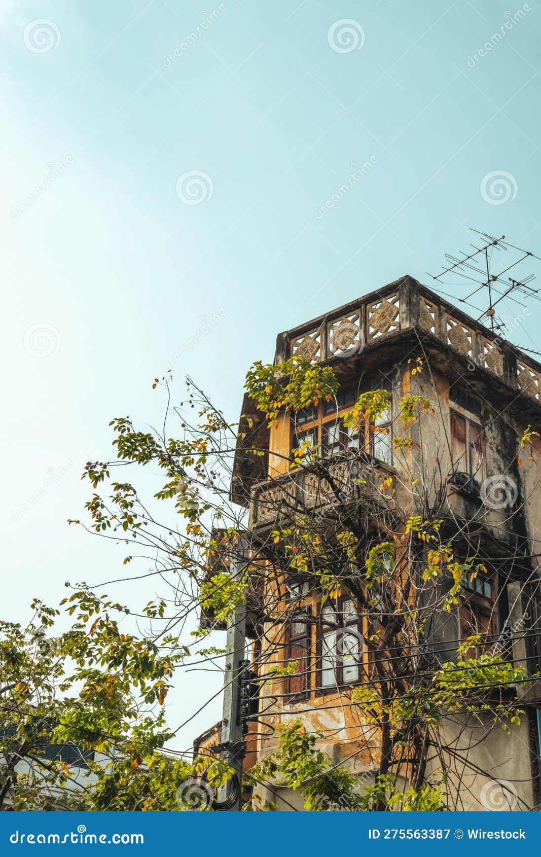 Aged, Corroded Building Situated Against a Vivid Blue Sky with the Sun ...