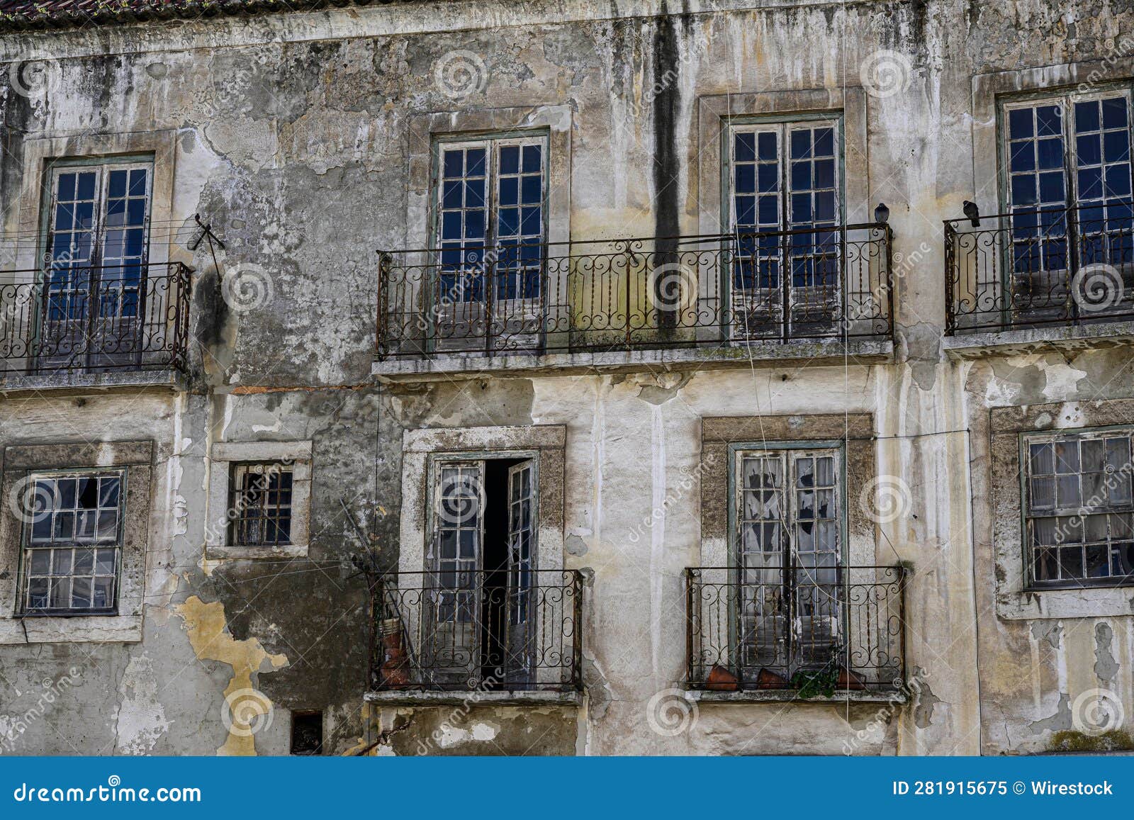 Aged and Deteriorated Building Featuring Multiple Windows and Doors in ...