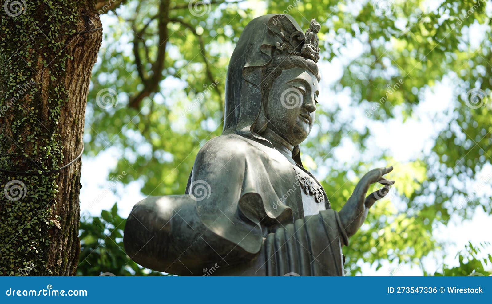 Aged Hindu Goddess Devi Statue Stands on a Lush Green Backdrop of Trees ...