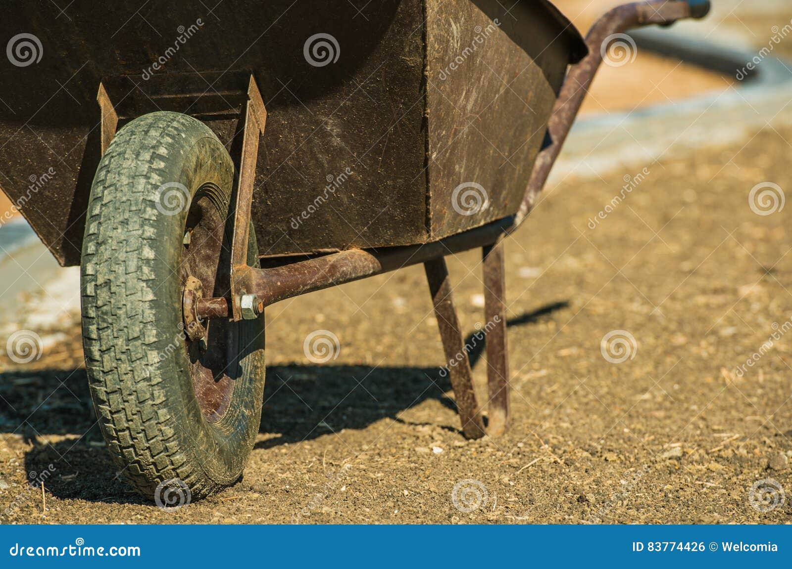 Aged Metal Wheelbarrow stock photo. Image of building - 83774426