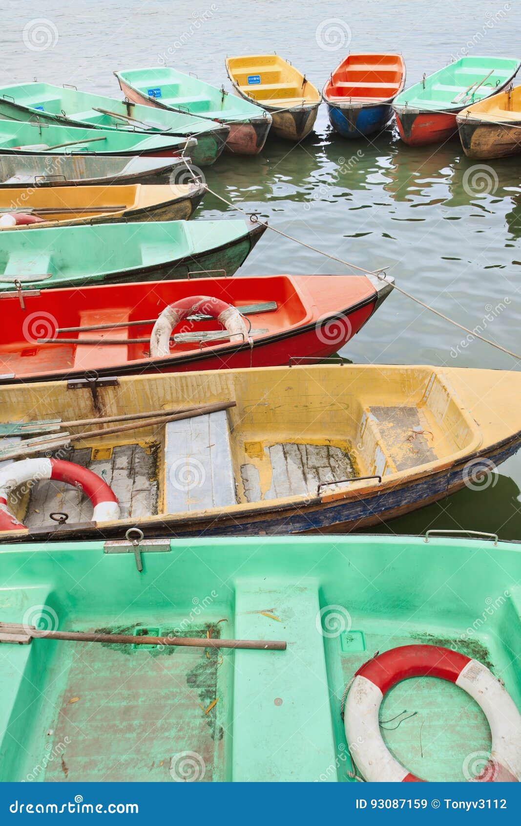 Aged Multi Colored Row Boats Moored in a Lake. Stock Image - Image of ...