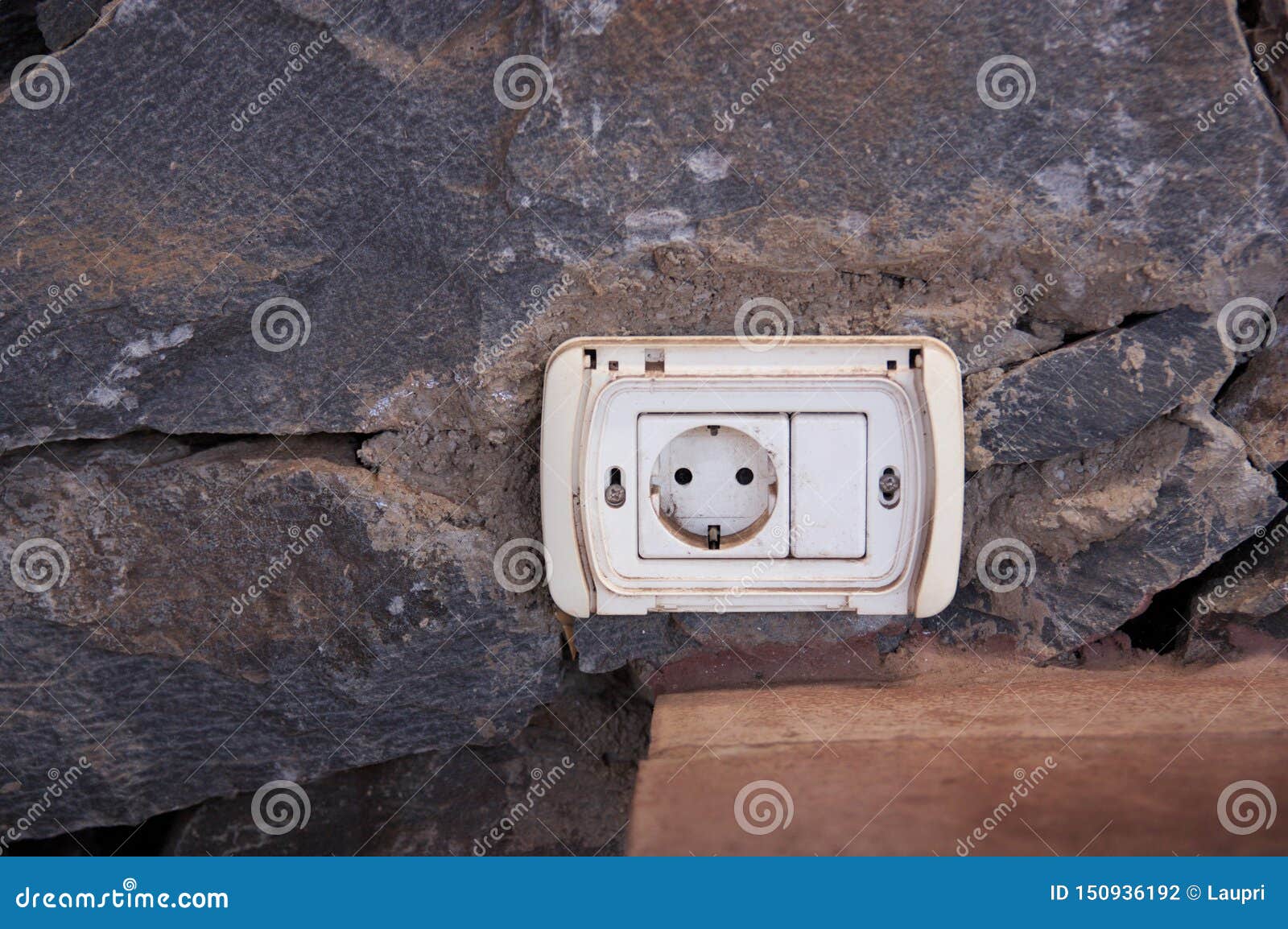 An Aged Plug Placed on a Rustic Stone Wall Stock Photo - Image of ...
