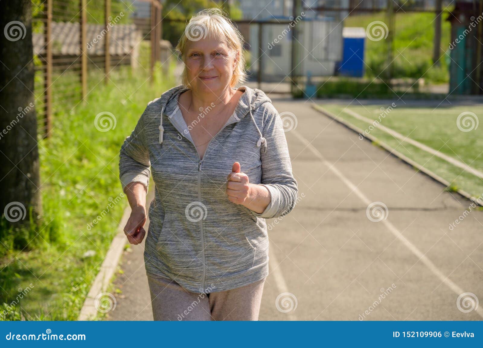 Aged woman jogging. stock photo. Image of aged, stadium - 152109906