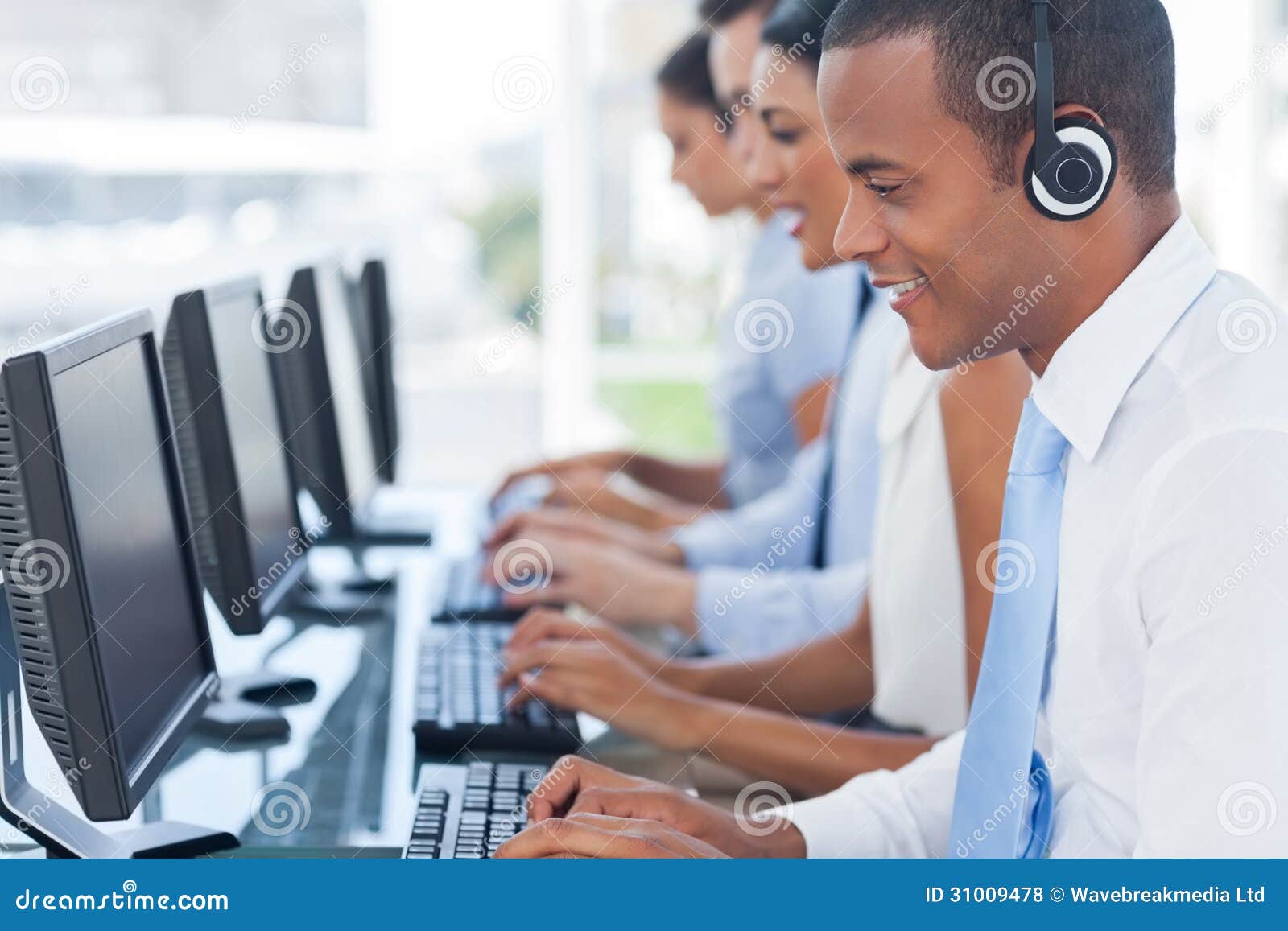 Agent Smiling while Working on His Computer Stock Photo - Image of ...