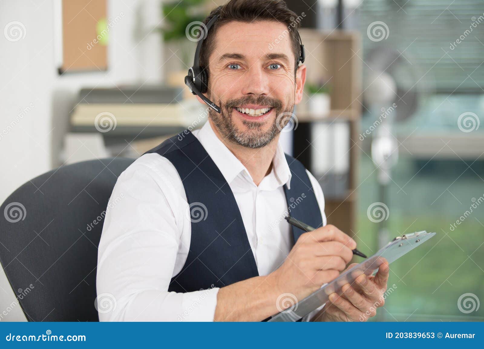 Agent Taking Notes while Talking with Customer Using Headset Stock ...
