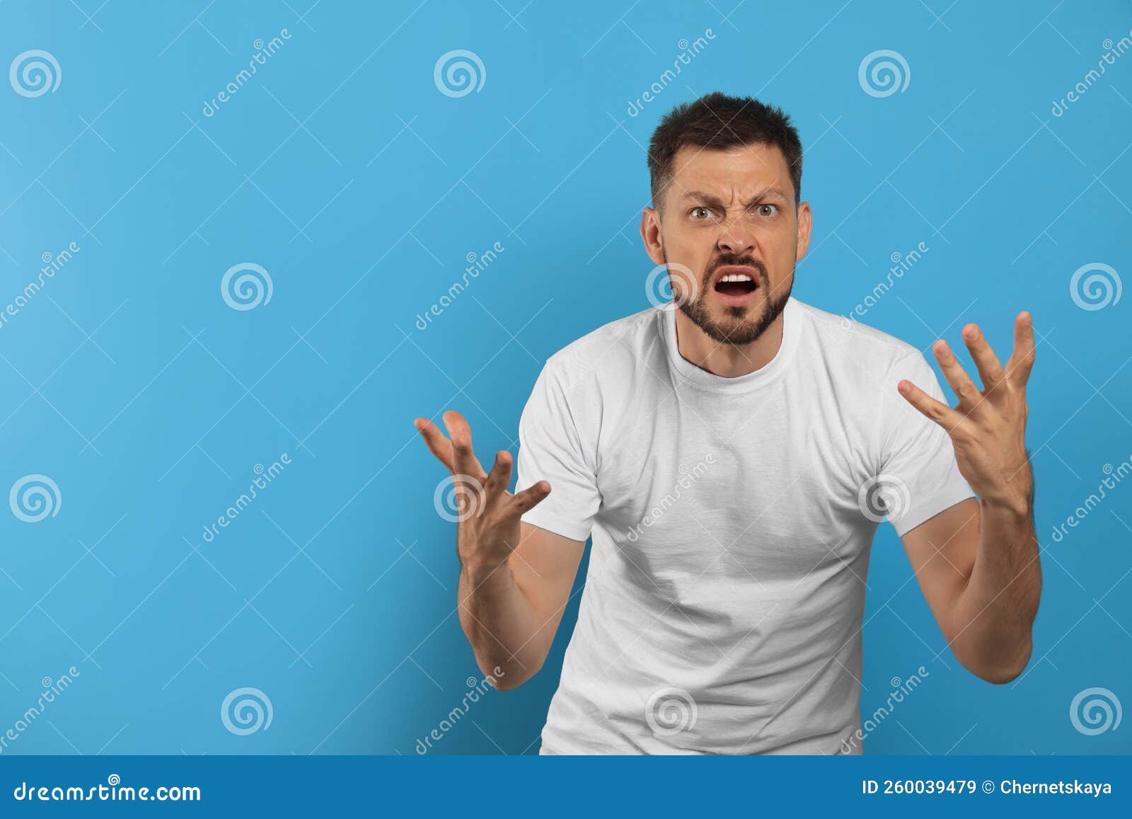 Aggressive Man on Light Blue Background, Space for Text Stock Image ...