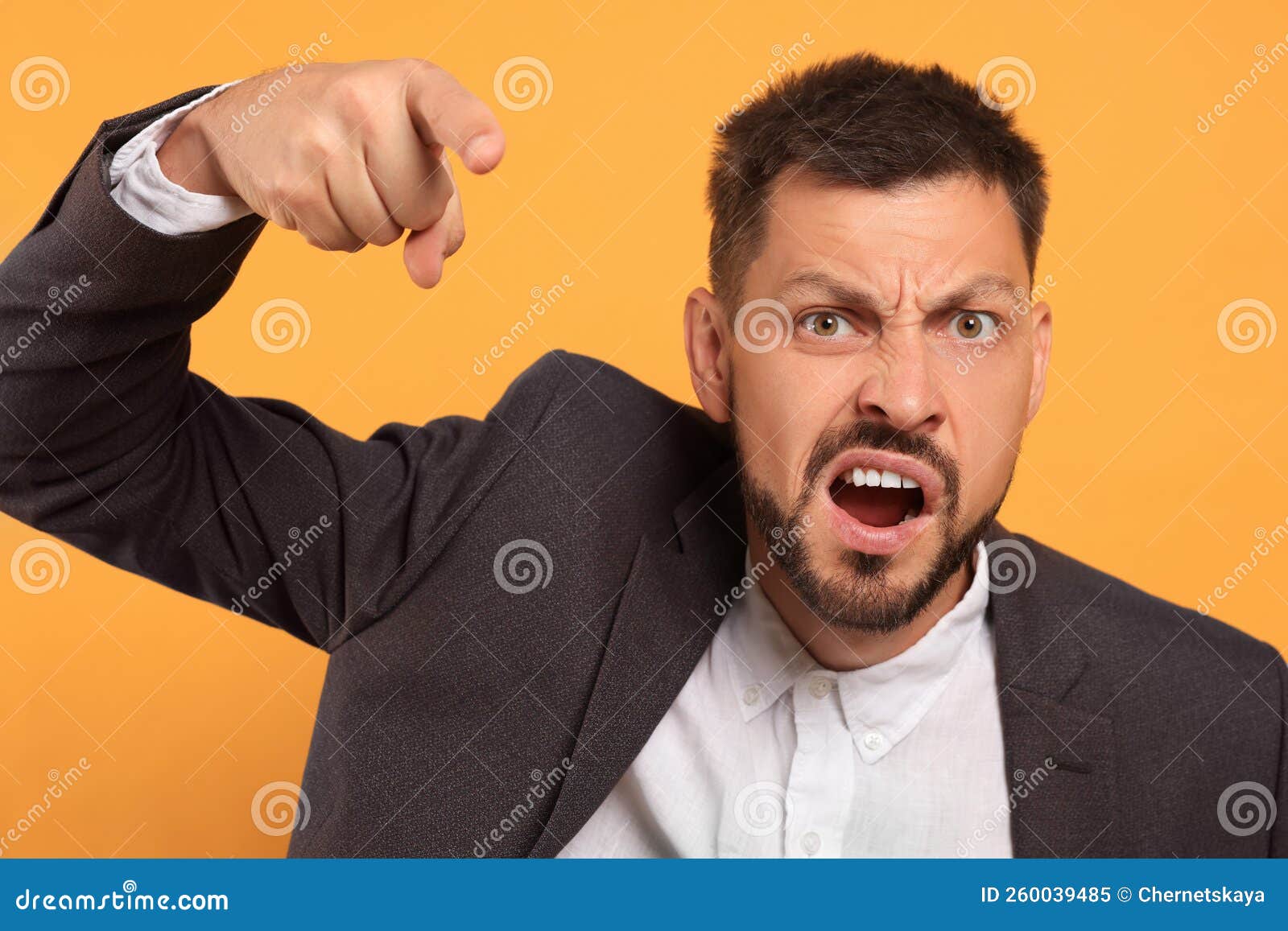 Aggressive Man Pointing on Orange Background. Hate Concept Stock Image ...