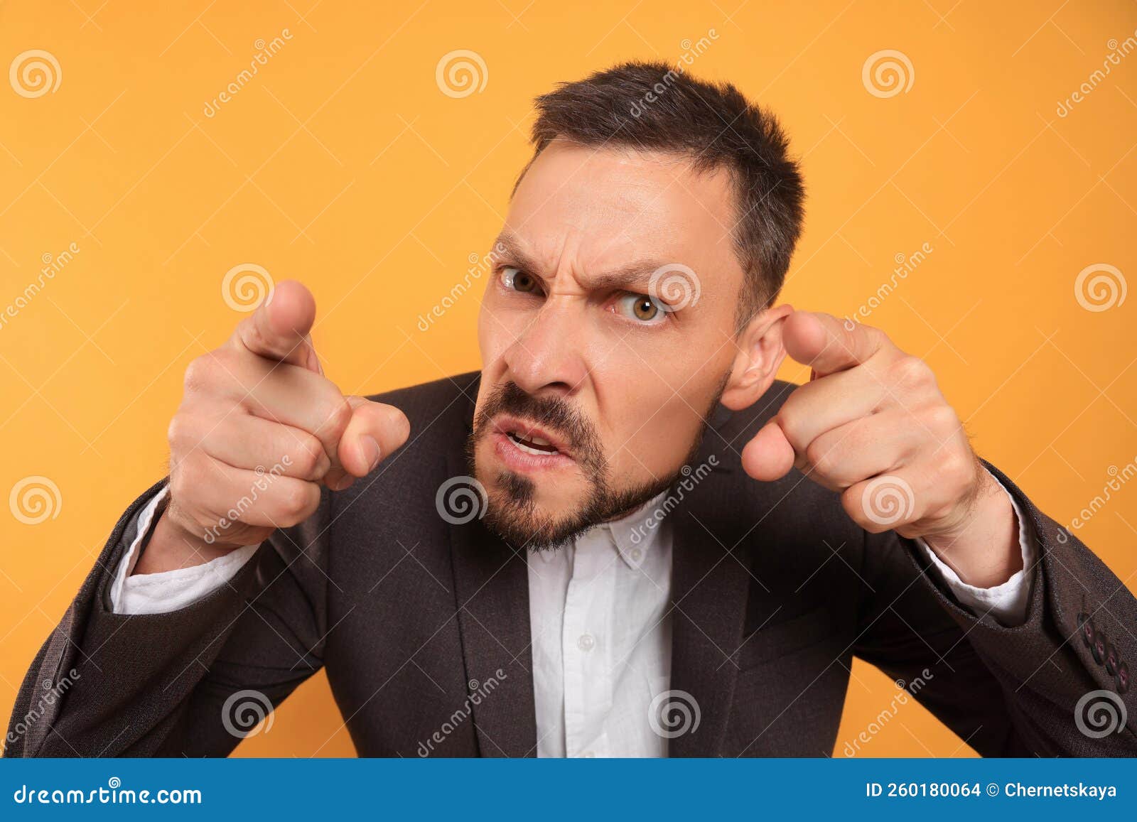 Aggressive Man Pointing on Orange Background. Hate Concept Stock Photo ...