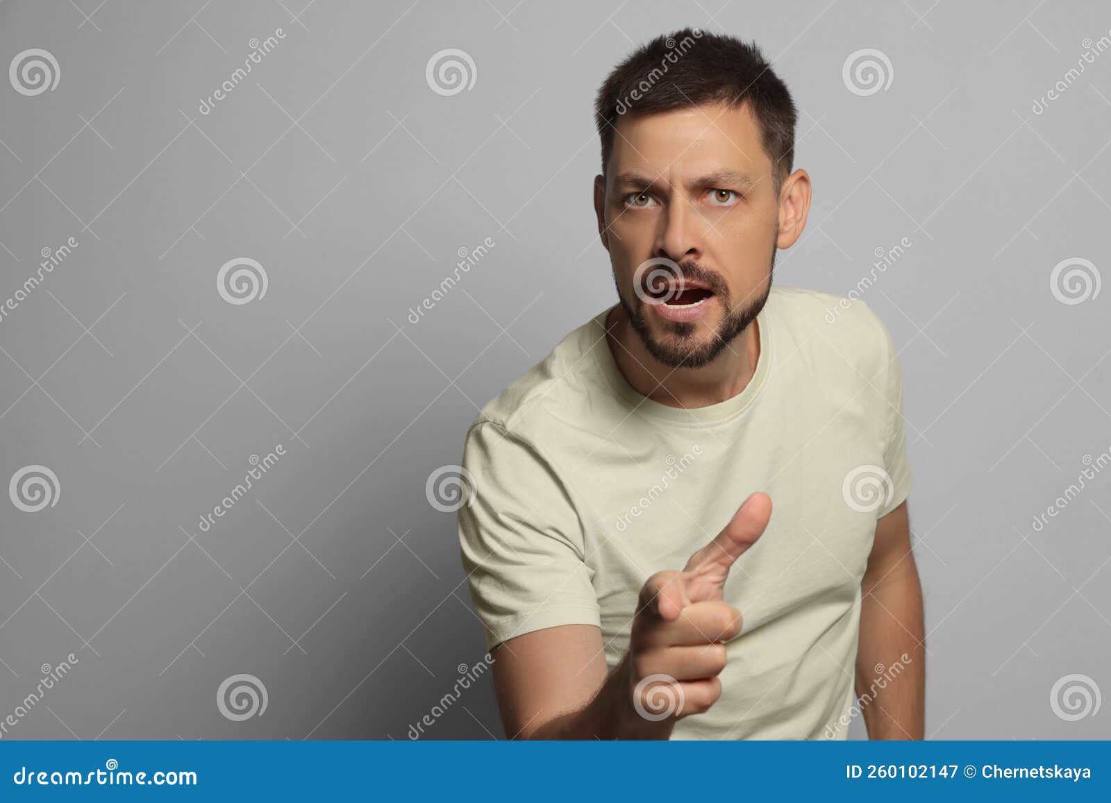 Aggressive Man Pointing on Grey Background, Space for Text Stock Image ...