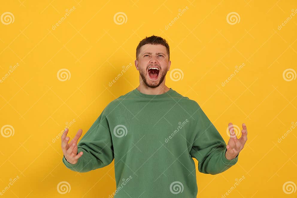 Aggressive Young Man Shouting on Orange Background Stock Image - Image ...