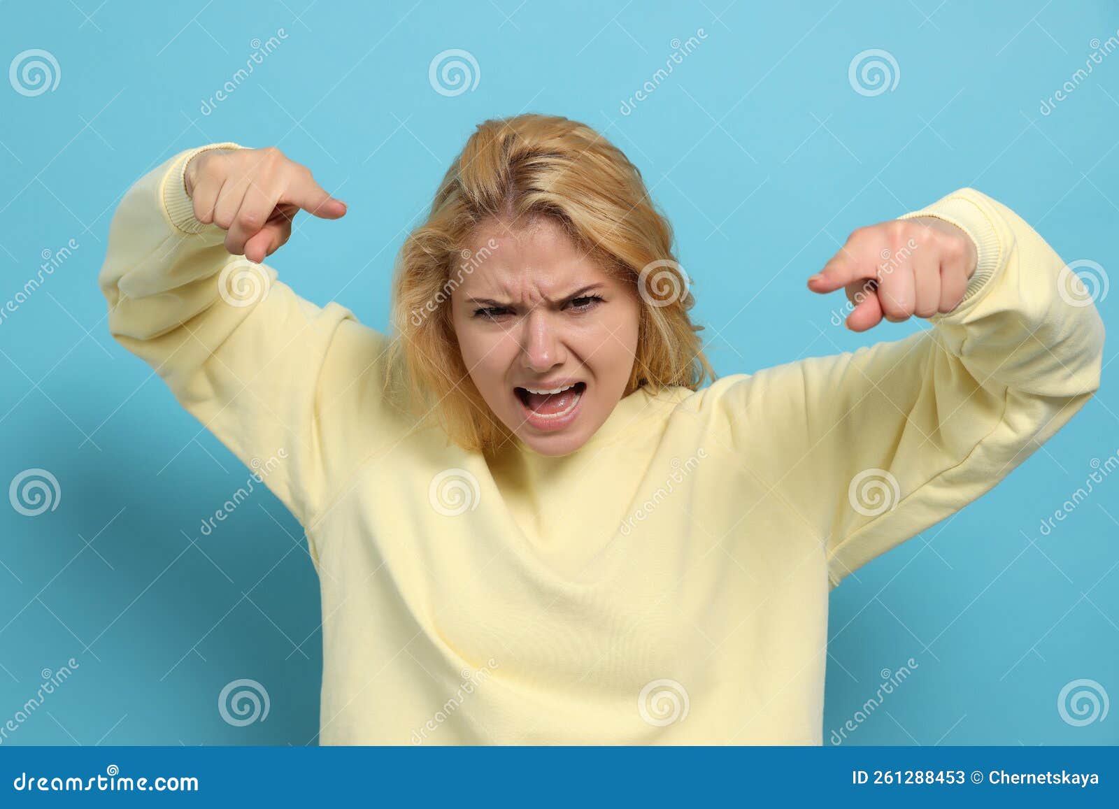 Aggressive Young Woman Pointing on Light Blue Background Stock Image ...