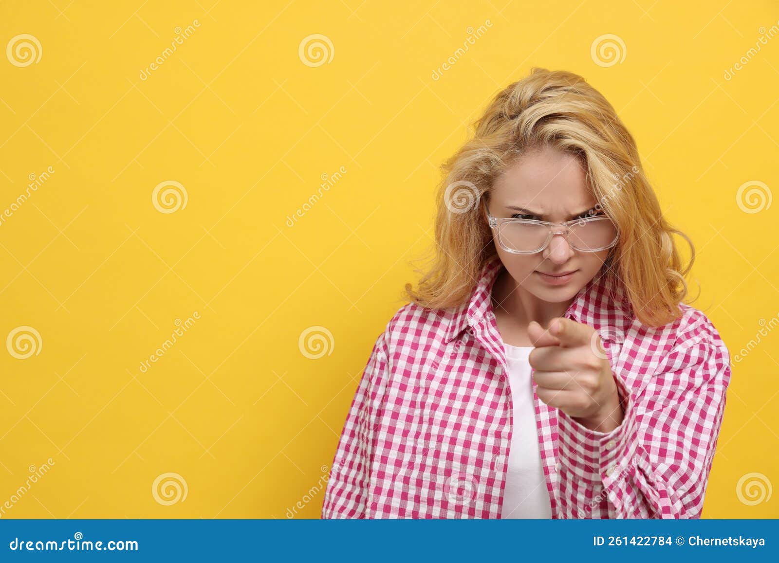 Aggressive Young Woman Pointing on Yellow Background. Space for Text ...