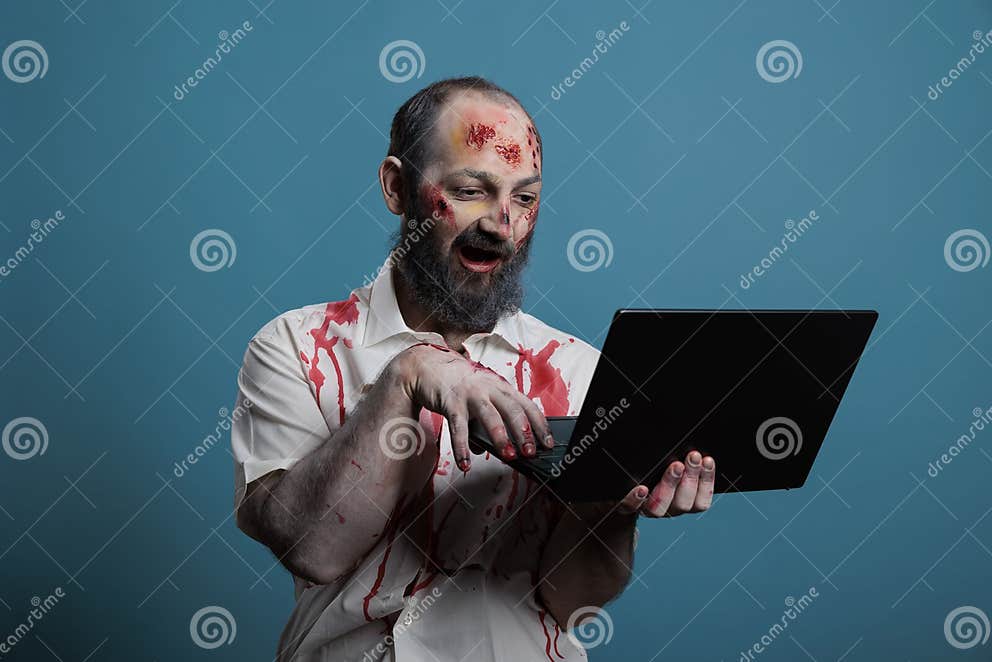 Aggressive Zombie Using Laptop Computer in Studio Stock Image - Image ...