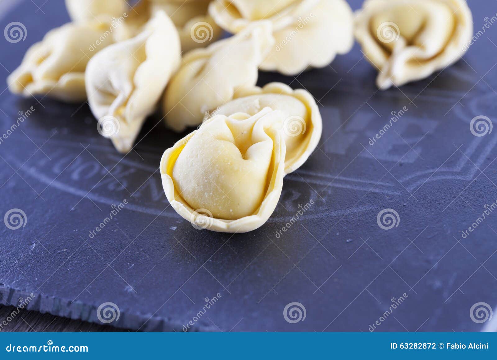 Agnolotti over black stone stock photo. Image of food - 63282872