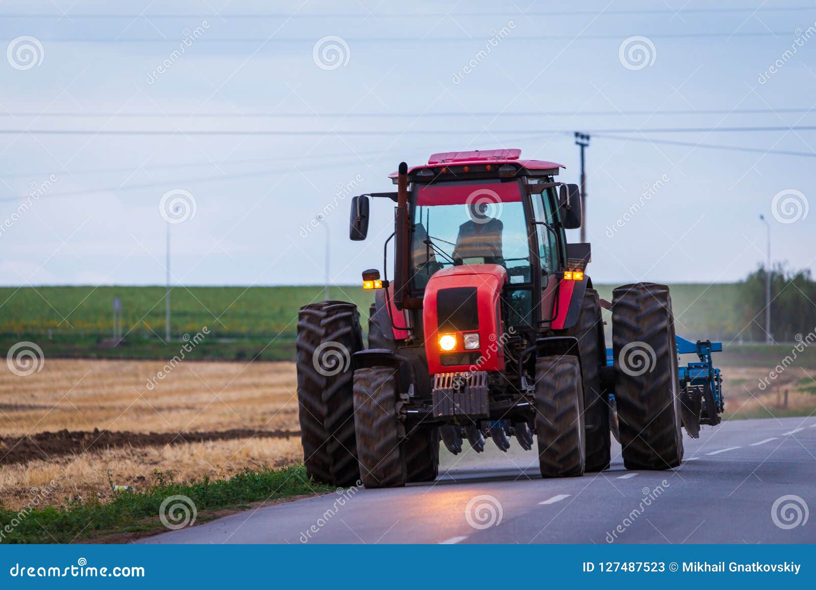 Agricultural Tractor Moving on the Asphalt Road after Working in Field ...