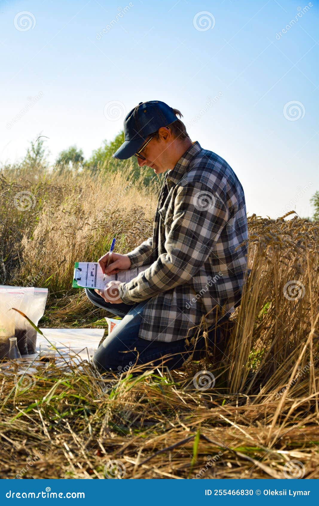 Agriculturist Taking Notes in Soil Sampling Information Sheet at Field ...