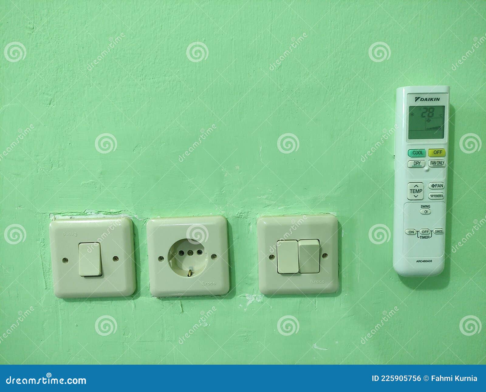 Air Conditioning Remote, Socket and Switch on the Wall Stock Photo ...