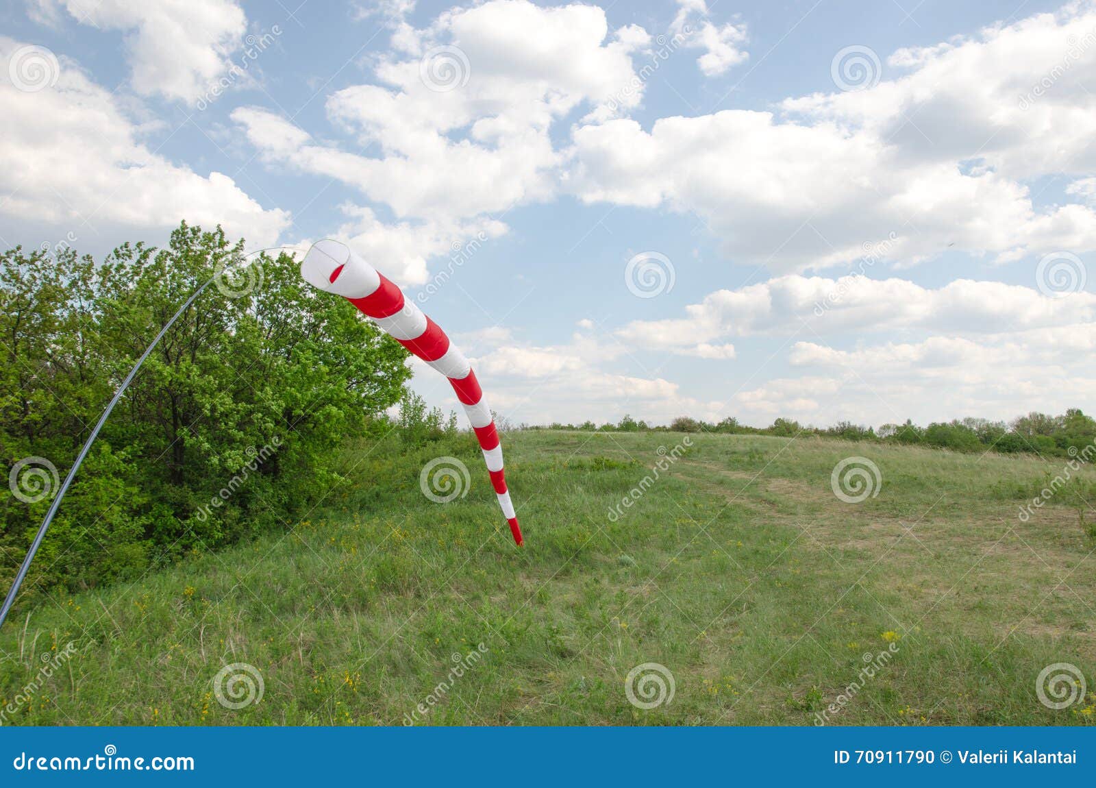 Air Field Direction Sign and a Wind Force Windsock Against the Blue Sky ...