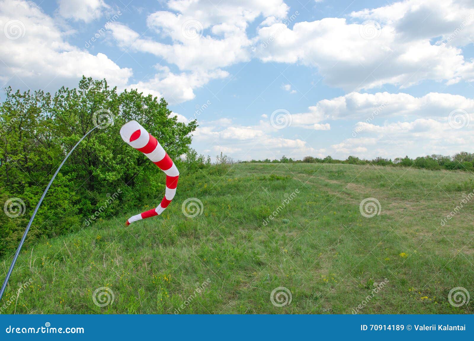 Air Field Direction Sign and a Wind Force Windsock Against the Blue Sky ...