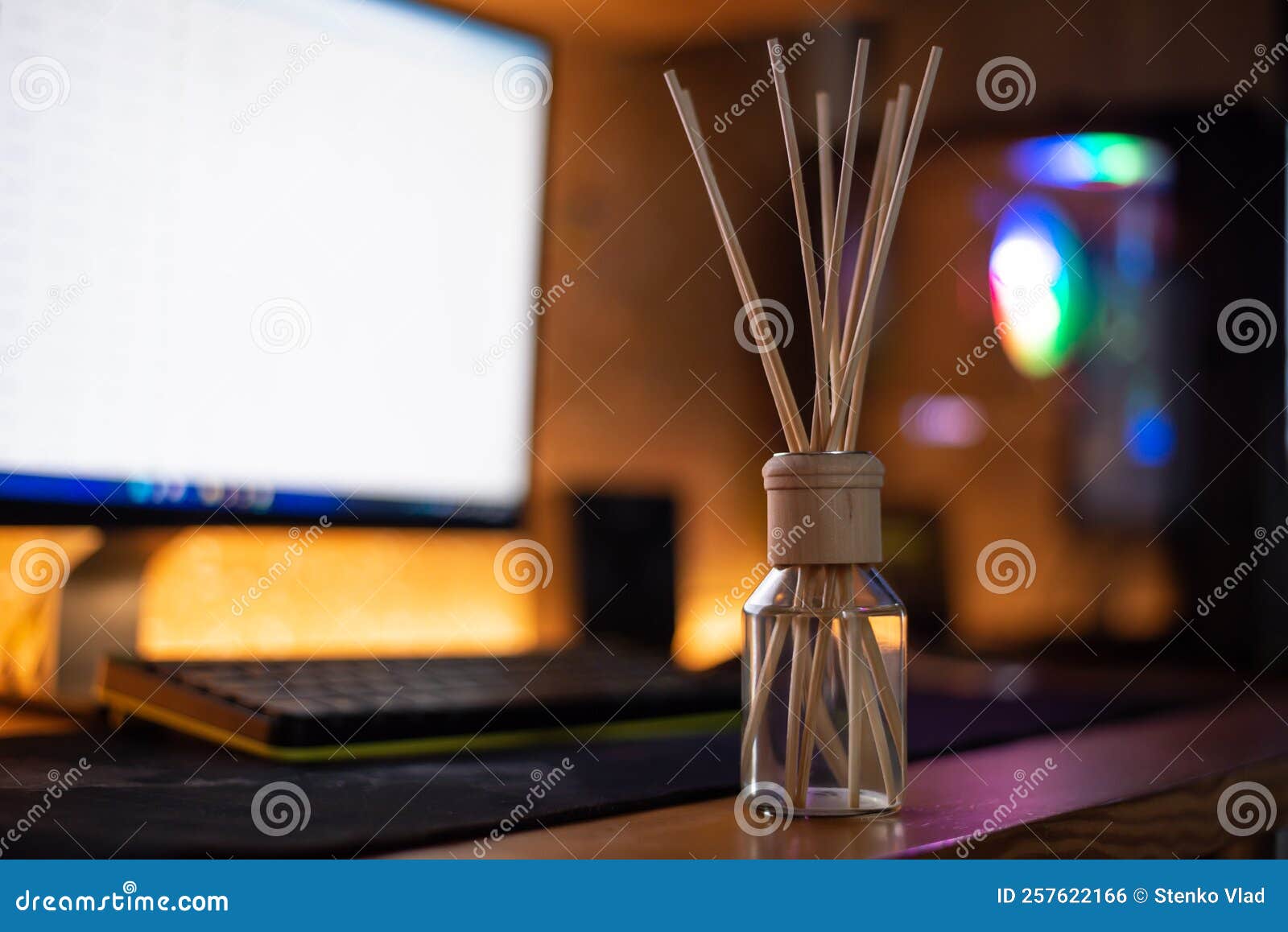Air Freshener Near the Computer. Reed Diffuser Wood Stock Photo - Image ...