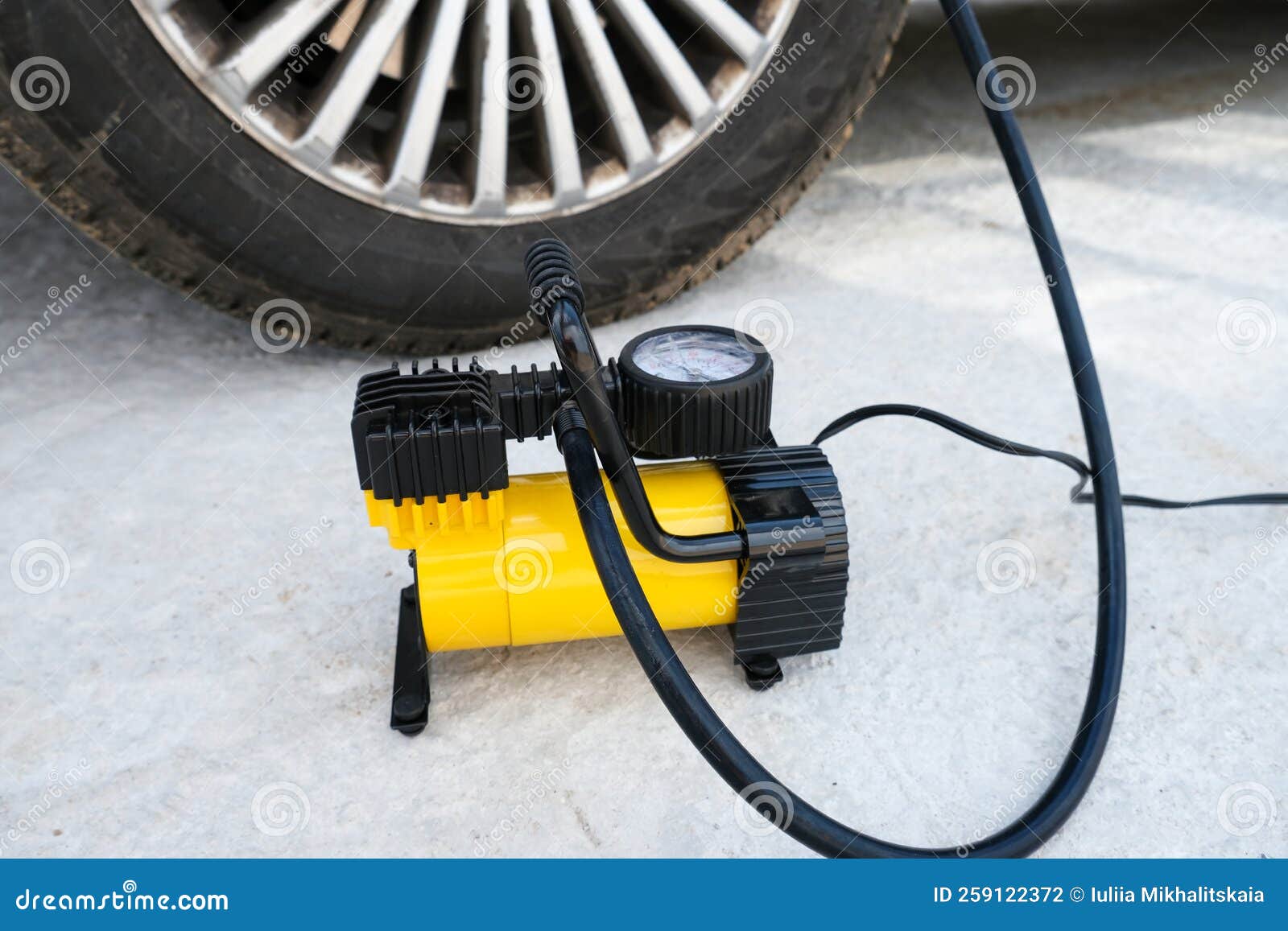 Air Pump Inflating a Wheel of a Broken Car, Car Breakdown Concept Stock ...