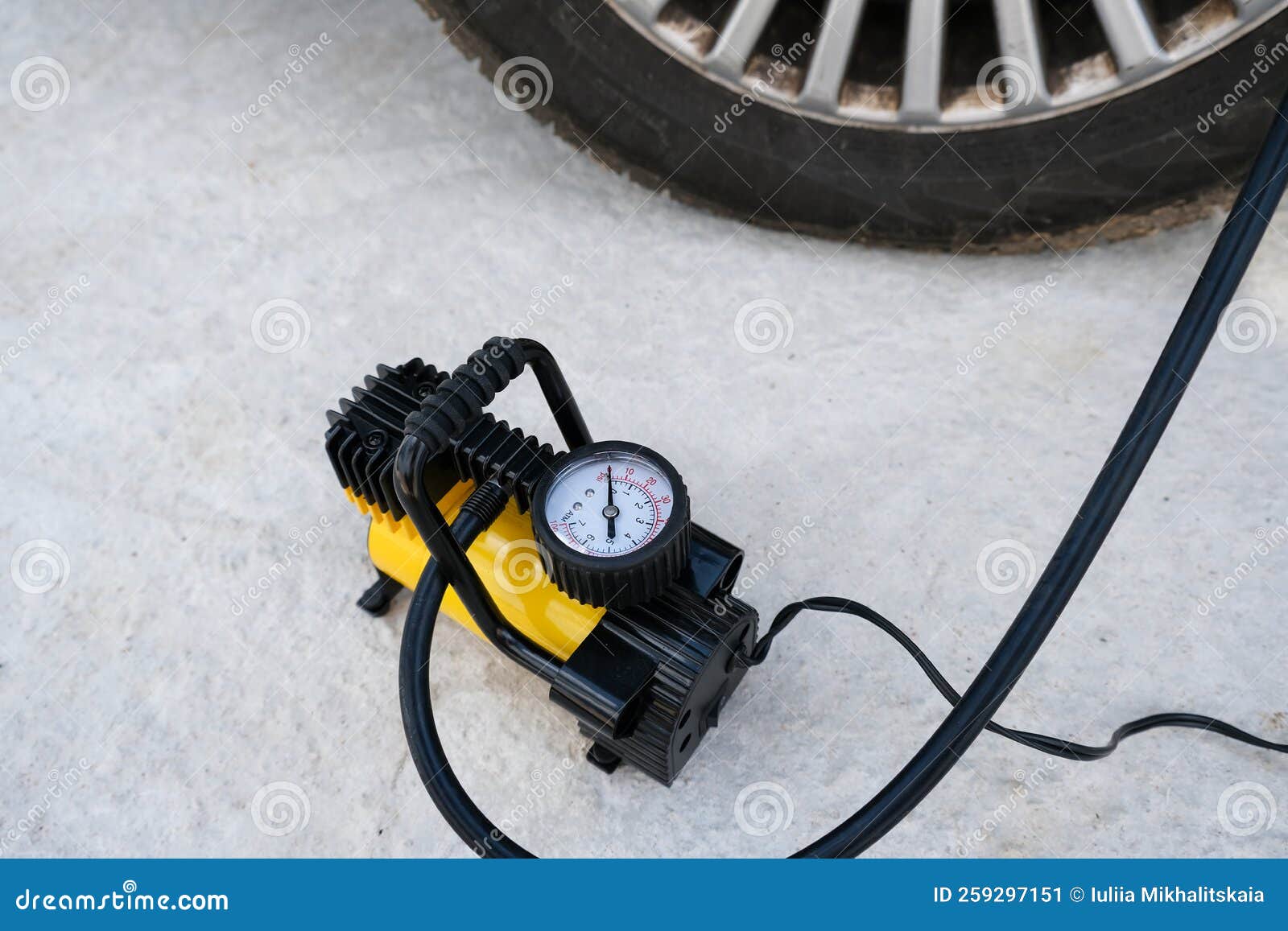 Air Pump Inflating a Wheel of a Broken Car, Car Breakdown Concept Stock ...